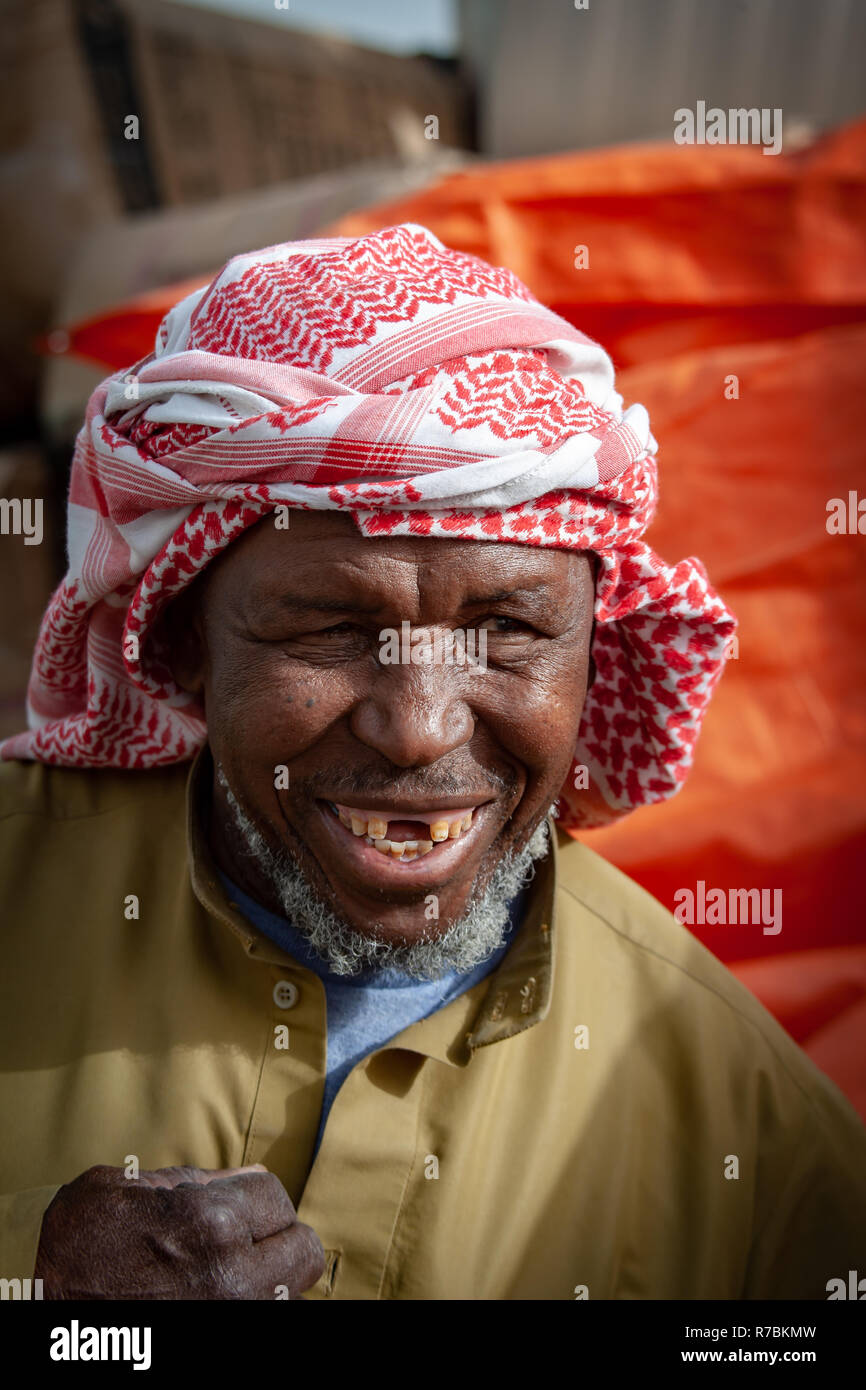 ghutra headdress wearing Smiling Market trader with missing teeth in a ...