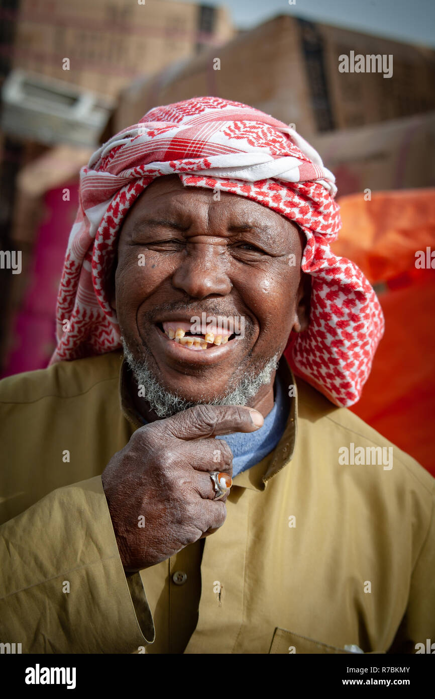ghutra headdress wearing Smiling Market trader with missing teeth in a ...