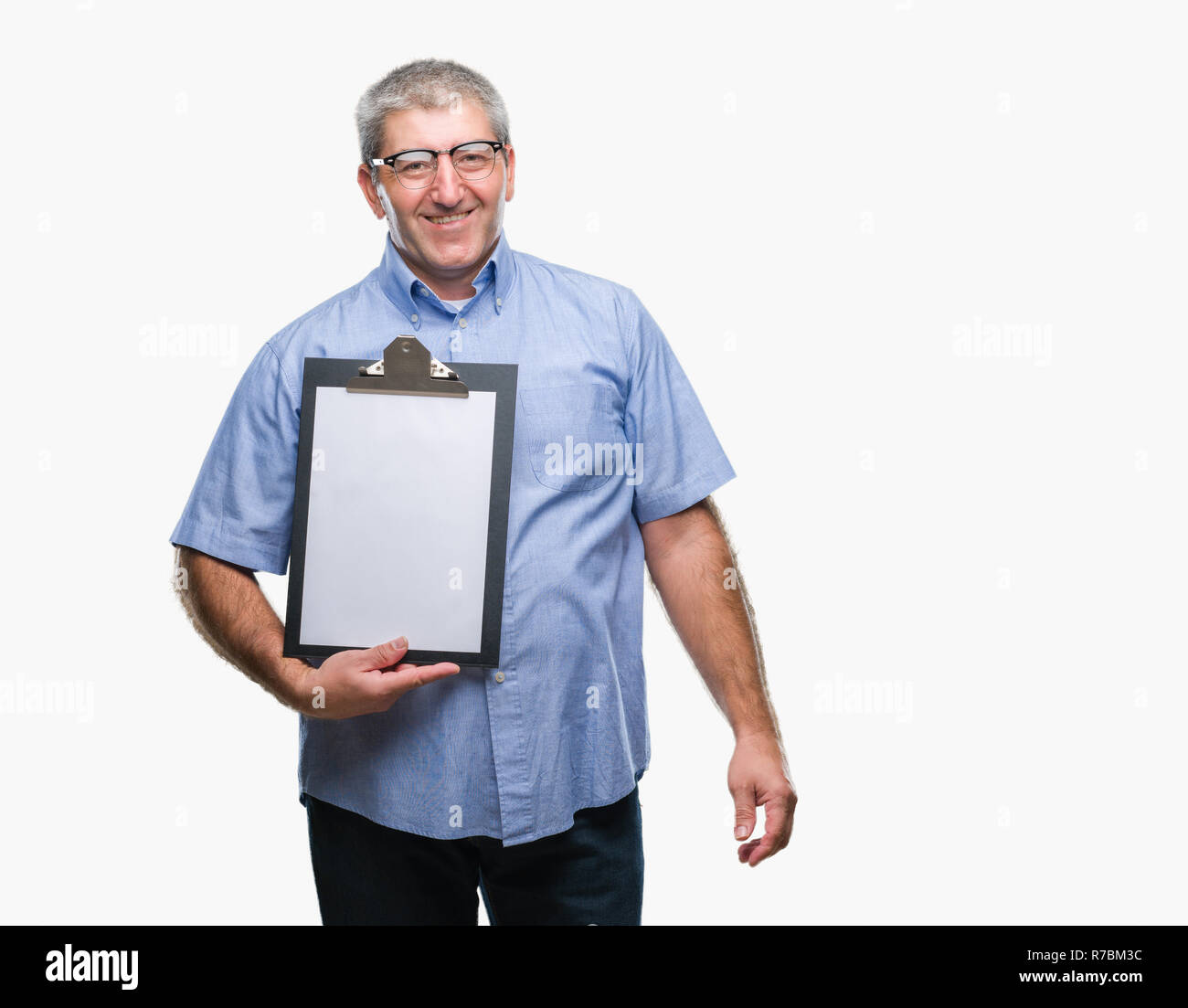 Handsome senior inspector man holding clipboard over isolated ...
