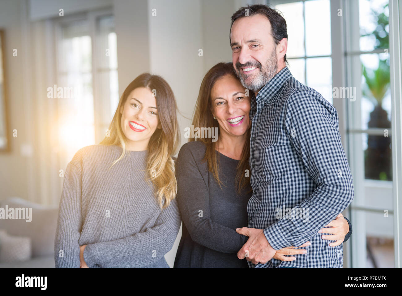 Beautiful family together. Mother, father and daughter smiling and ...