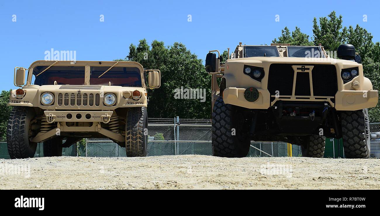 A Humvee and a Joint Light Tactical Vehicle stand on display for size ...