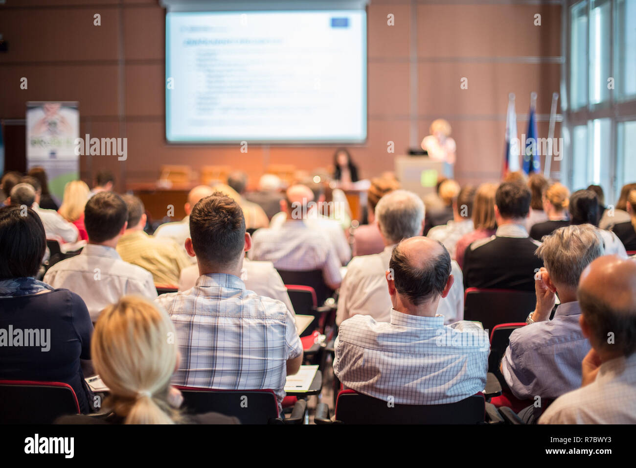 Woman giving presentation on business conference Stock Photo - Alamy