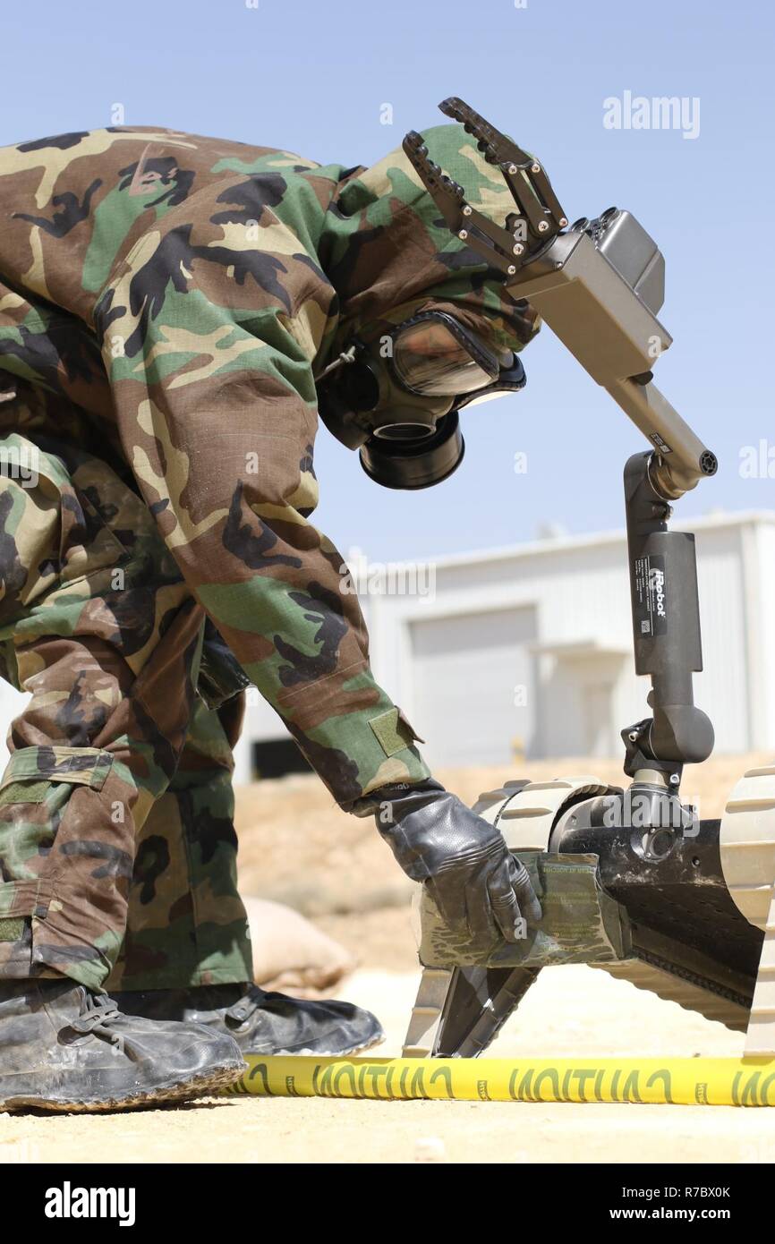 A Jordan Armed Forces soldier checks a recon robot for contamination ...