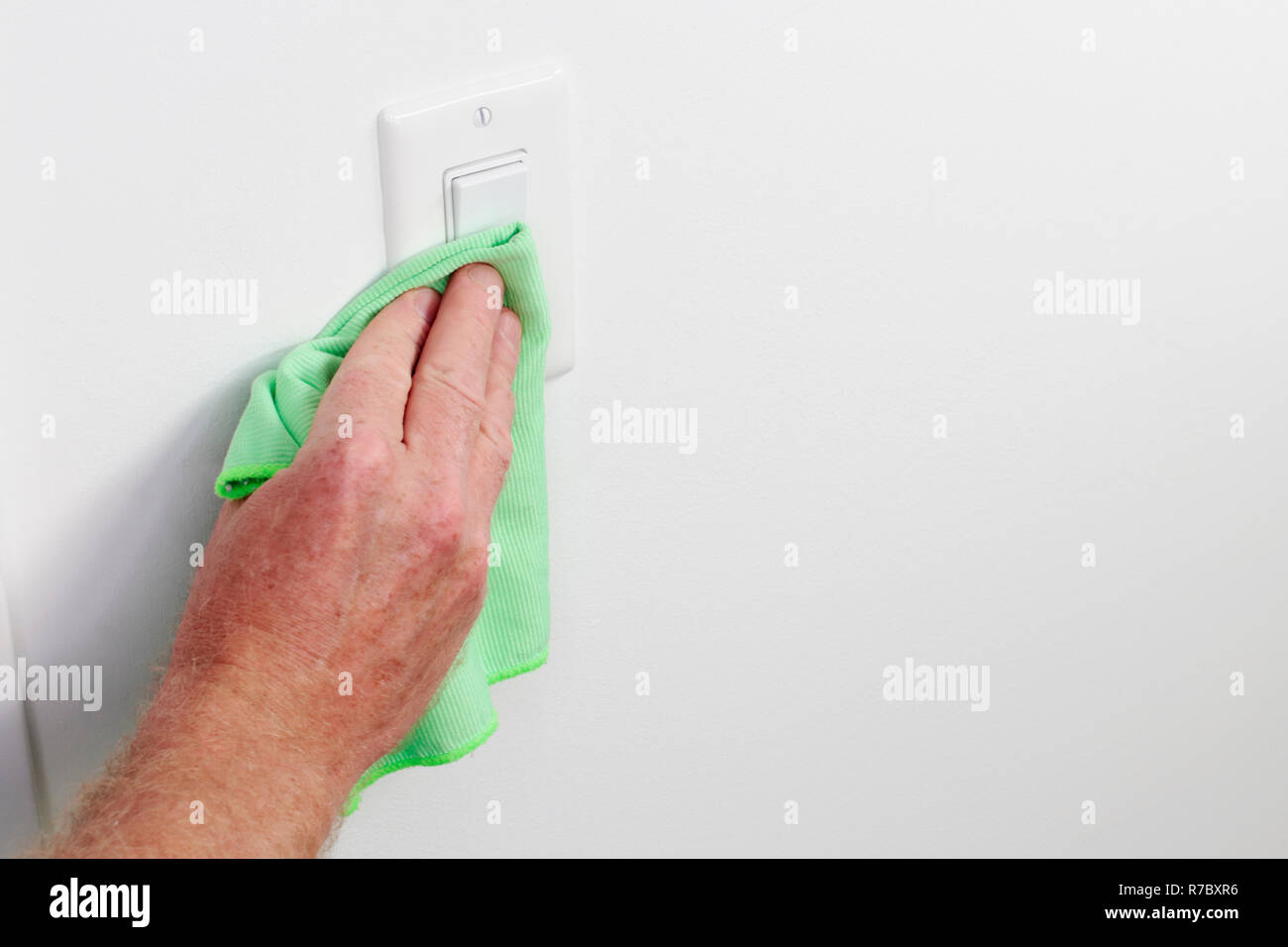 Hand Cleaning Light Switch Panel with Green Cloth Stock Photo - Alamy