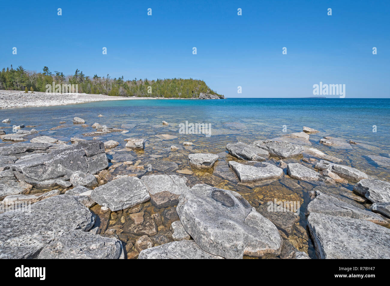 Calm Waters and Rocks on a Remote Lakeshore Stock Photo - Alamy