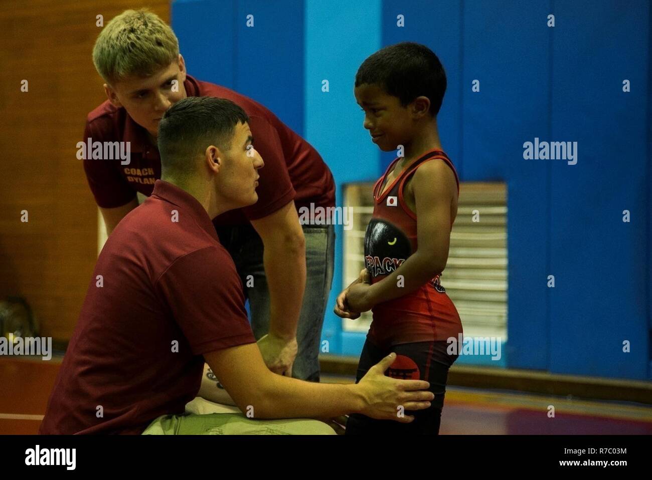 Cpl. Tylan Davis, left, coaches a wrestler on his team during the ...