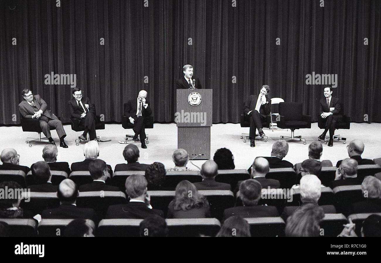 THERE ARE A GROUP OF MEN ON STAGE WITH ONE MAN AT THE PODIUM GIVING A ...