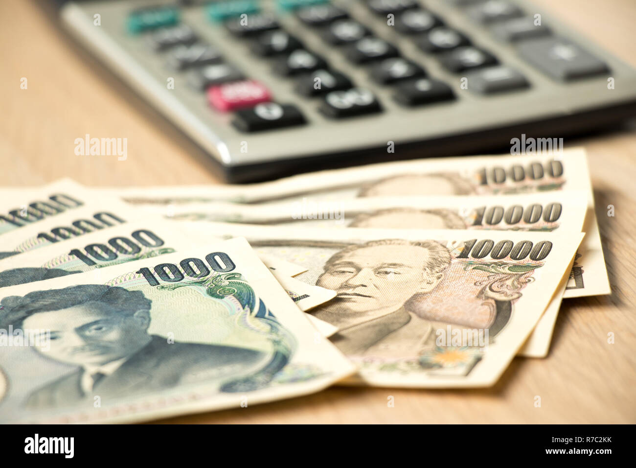 Japanese yen banknote and calculator on wood table background Stock ...