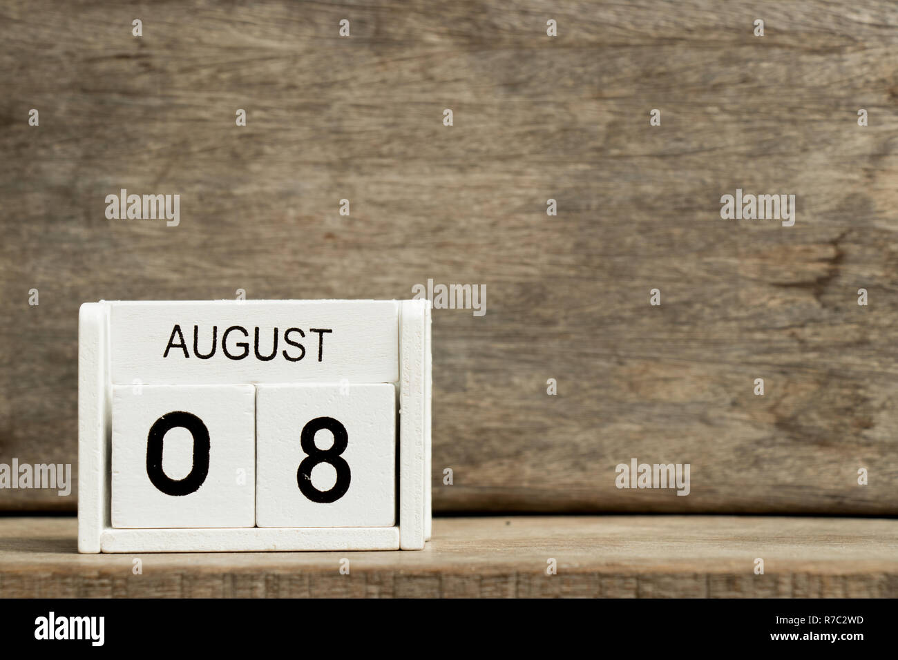 White block calendar present date 8 and month August on wood background ...