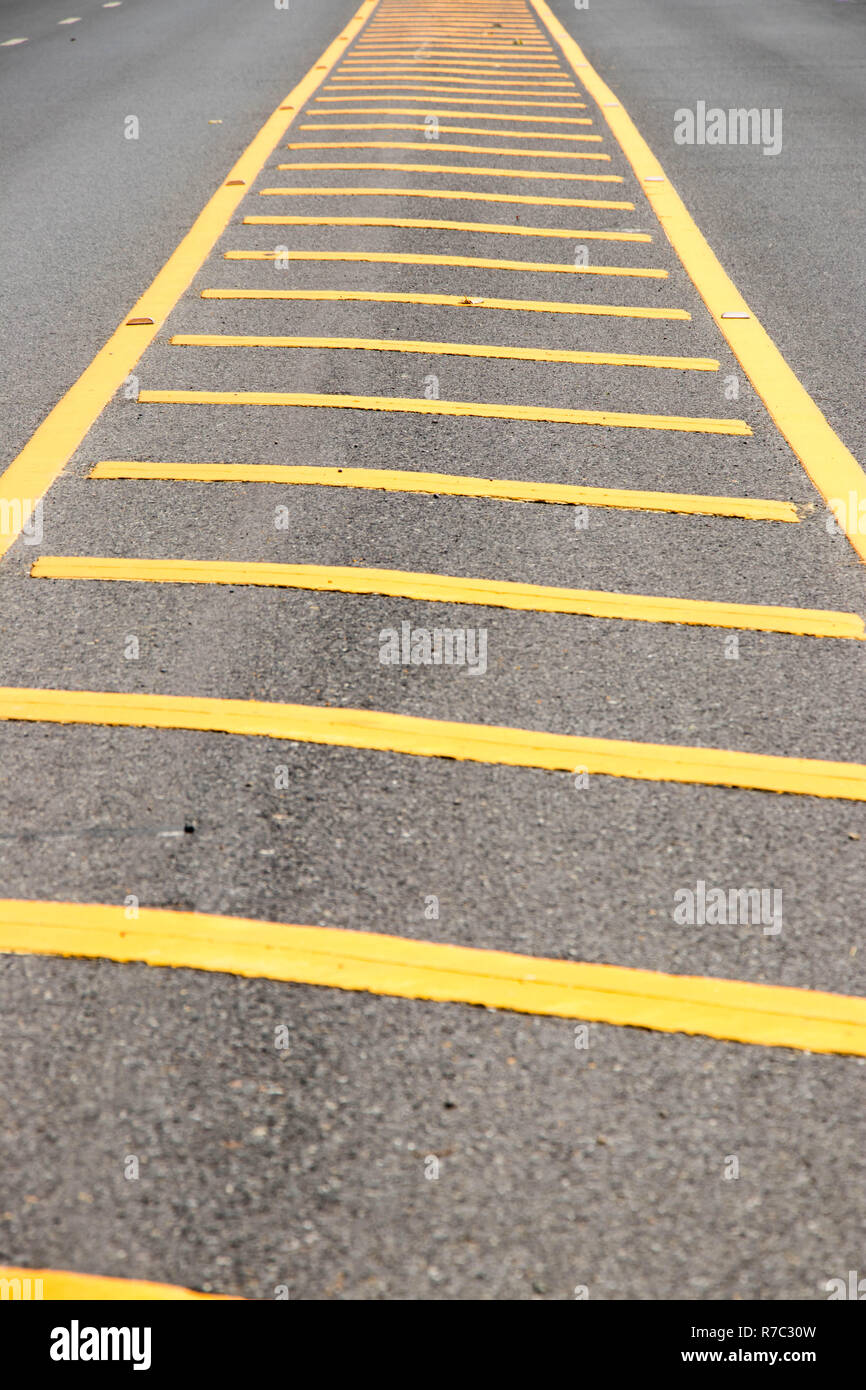 Yellow color road line on asphalt background Stock Photo - Alamy