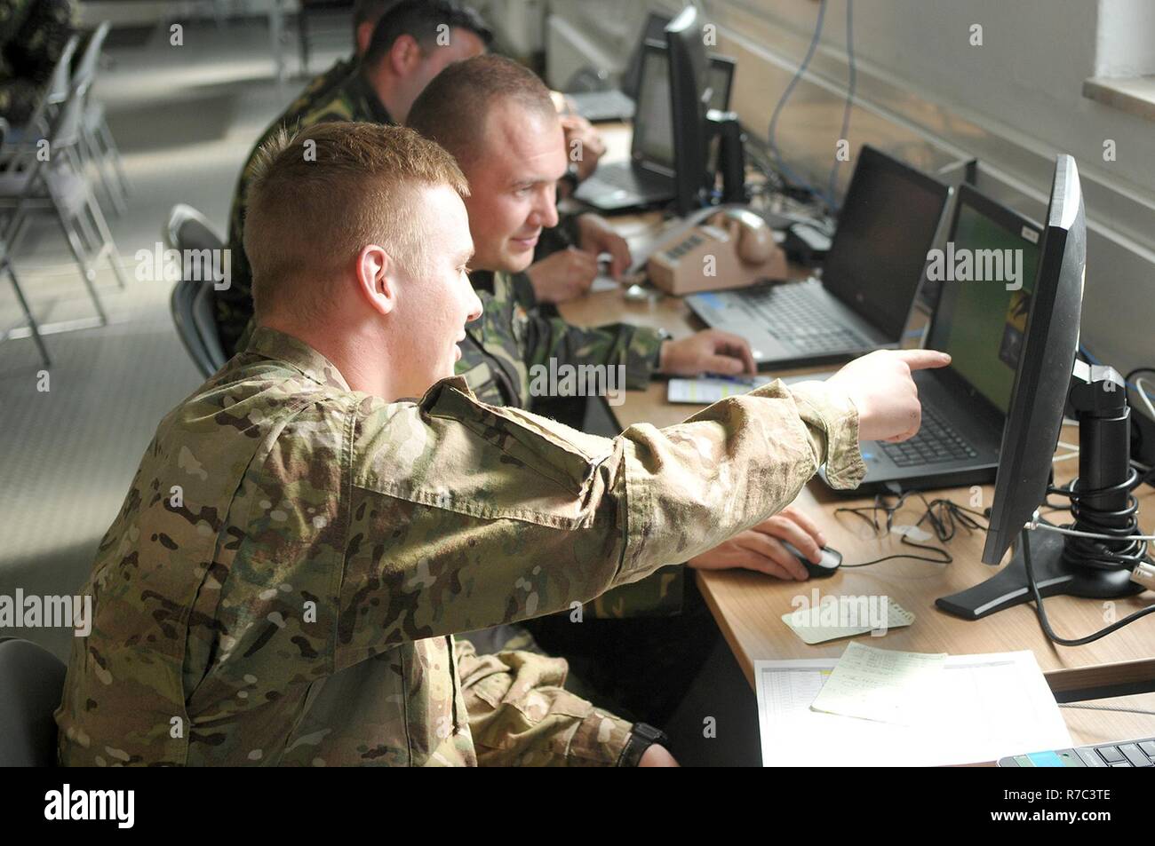 2nd Lt. Elliot Johnson (front), an assistant fire support officer with ...