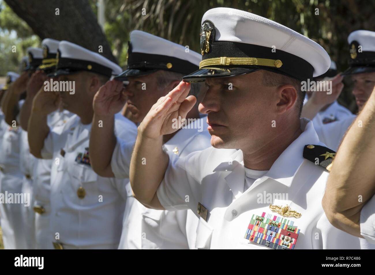 JACKSONVILLE, Fla. (May 17, 2017) Sailors salute while taps is played ...