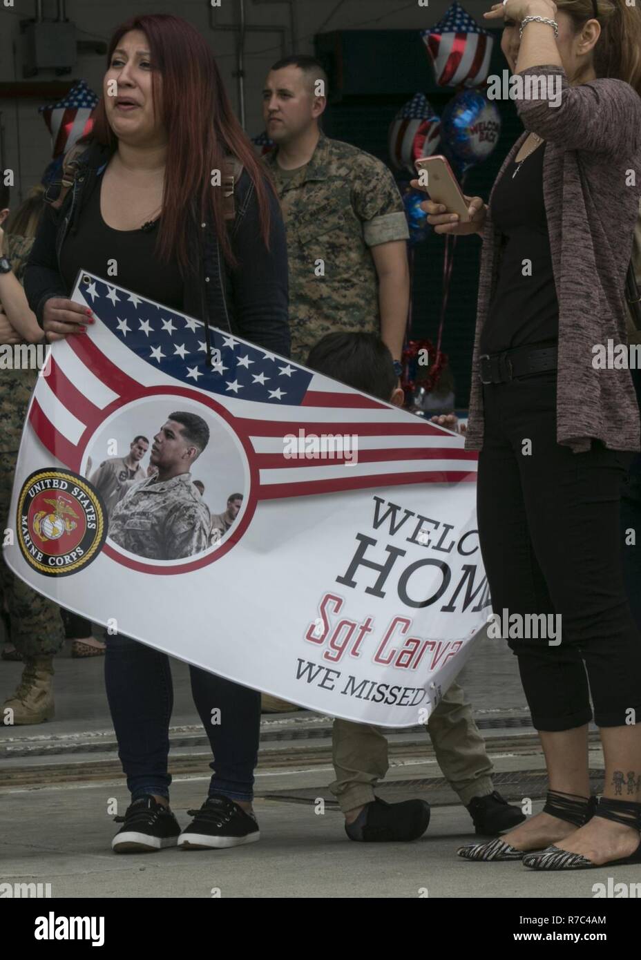 Family members wait for U.S. Marine Corps Sgt. Jose Carvajal, a ...