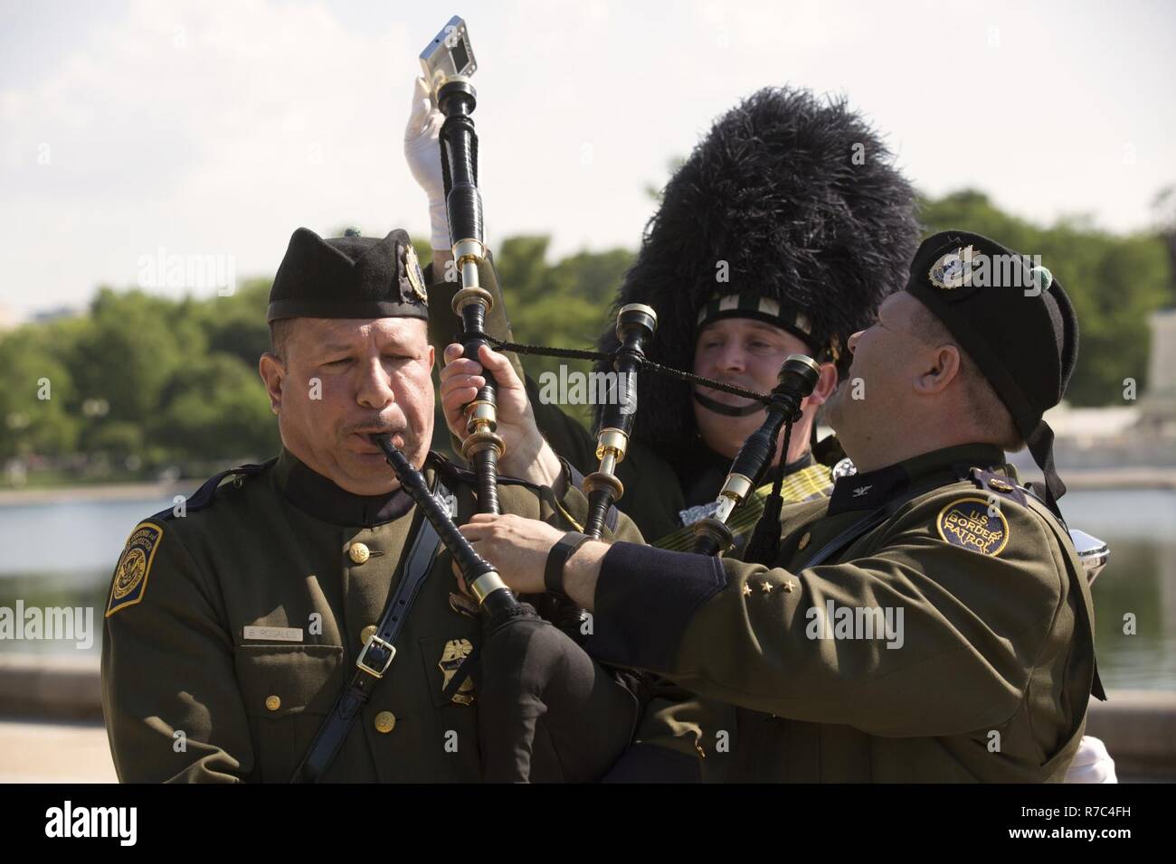 Members of the U.S. Border Patrol Pipes and Drums tune a set of ...