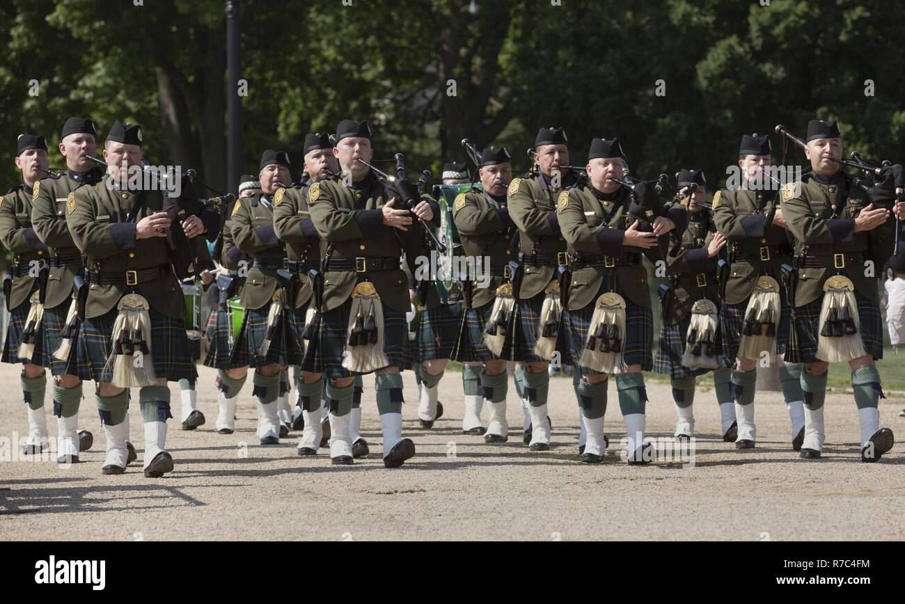 Members of the U.S. Border Patrol Pipes and Drums march in formation ...
