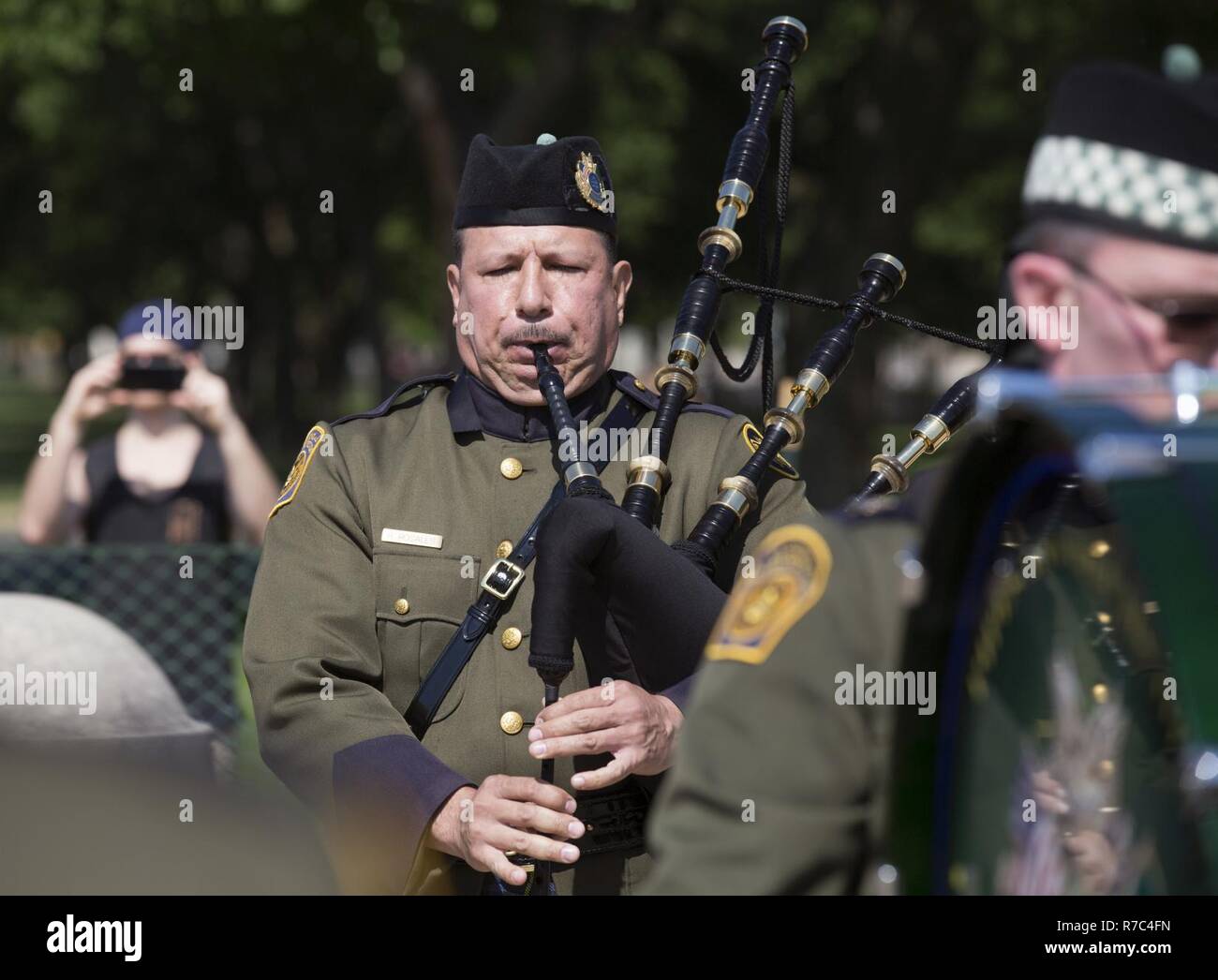 A members of the U.S. Border Patrol Pipes and Drums plays his bagpipes ...