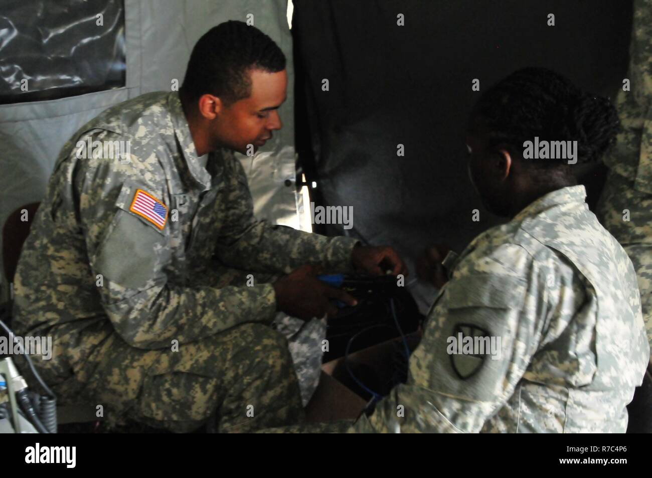 1st Lt. Michael McDonald shows Spc. Shareen Lang, 104th Troop Command ...