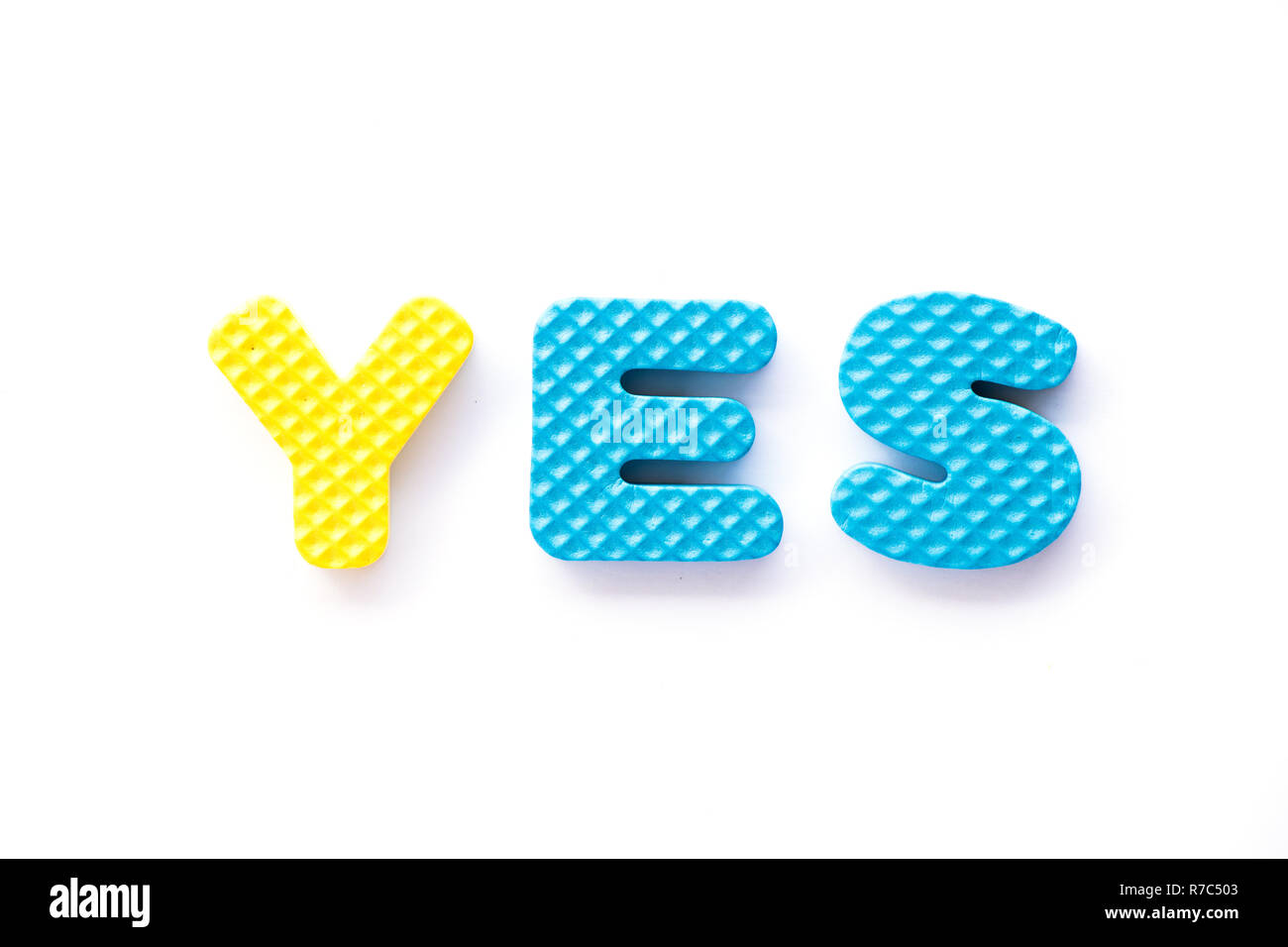 Color toy foam alphabet in word yes on white background Stock Photo - Alamy