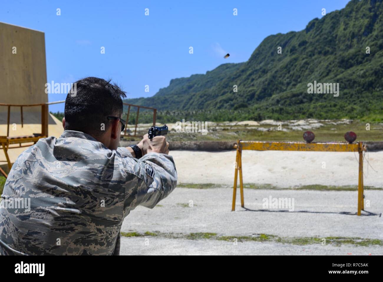 An Airman fires an M9 pistol during the Leadership Shooting Competition ...