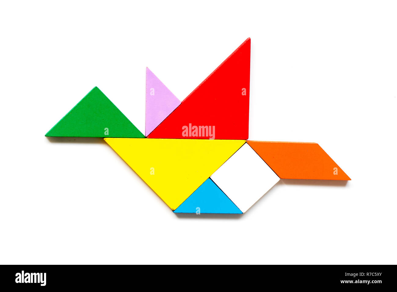 Color wood tangram puzzle in flying bird shape on white background ...