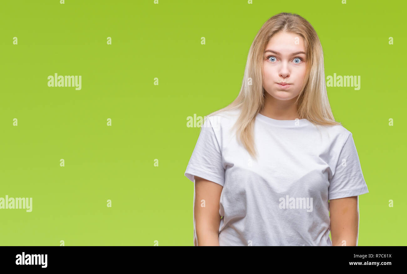 Young caucasian woman over isolated background puffing cheeks with ...