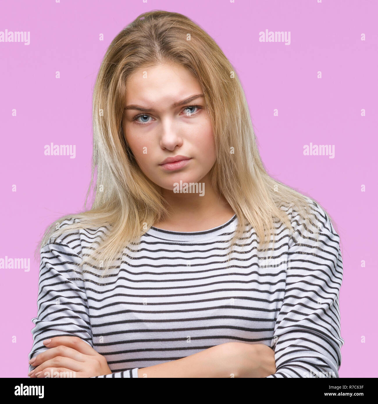 Young caucasian woman over isolated background skeptic and nervous ...