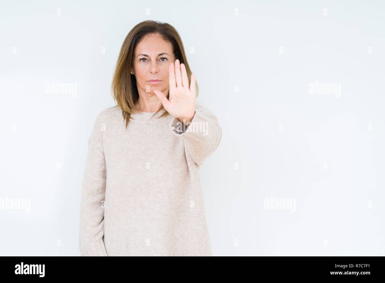 Beautiful middle age woman over isolated background doing stop sing ...