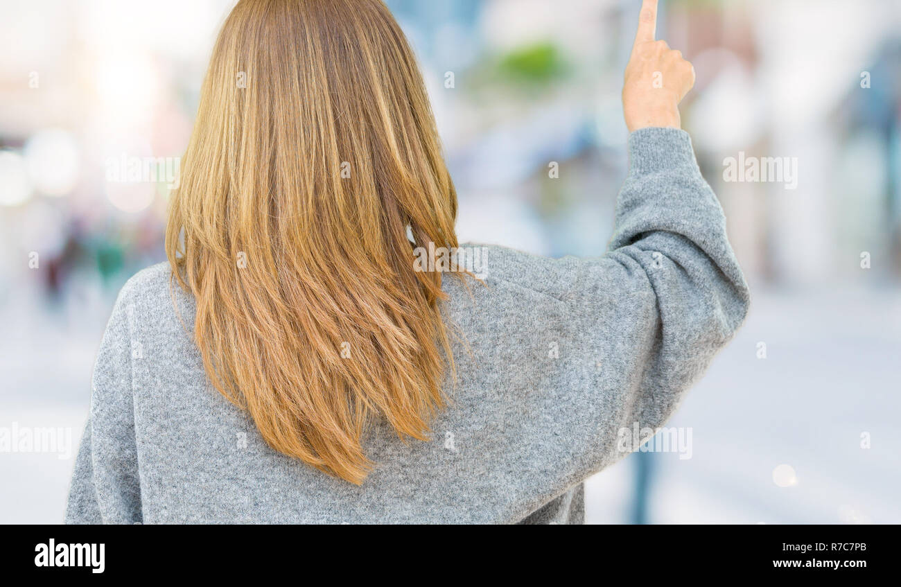Beautiful middle age woman wearing winter sweater over isolated ...
