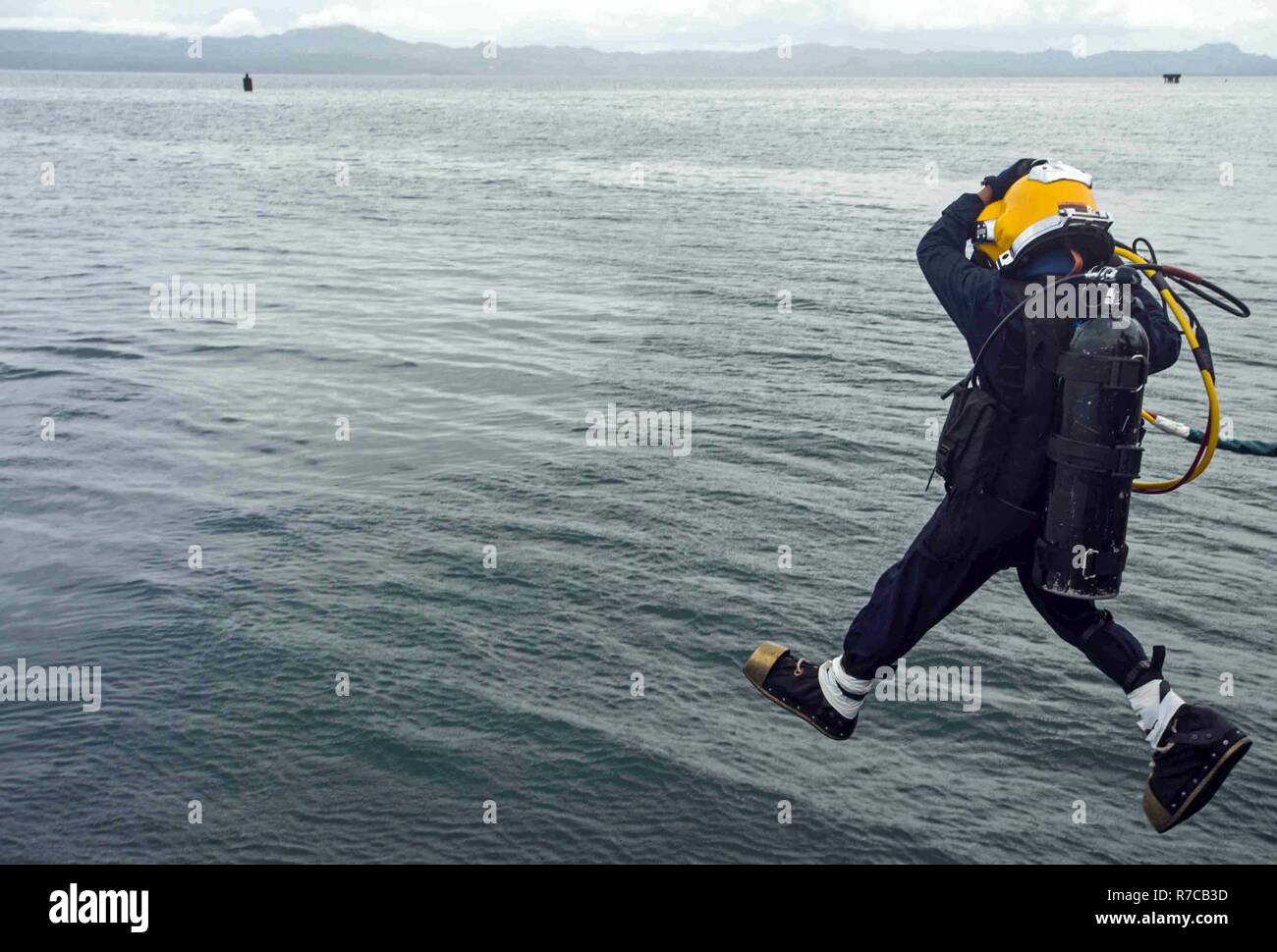 A Philippine Sailor with an underwater construction team enters the ...