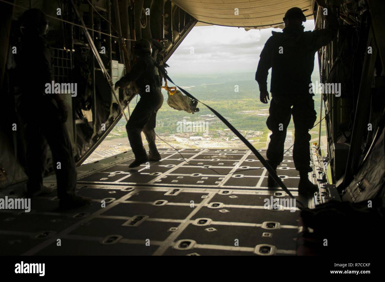 U.S. Air Force loadmasters pull in deployment bags back into a C-130 ...