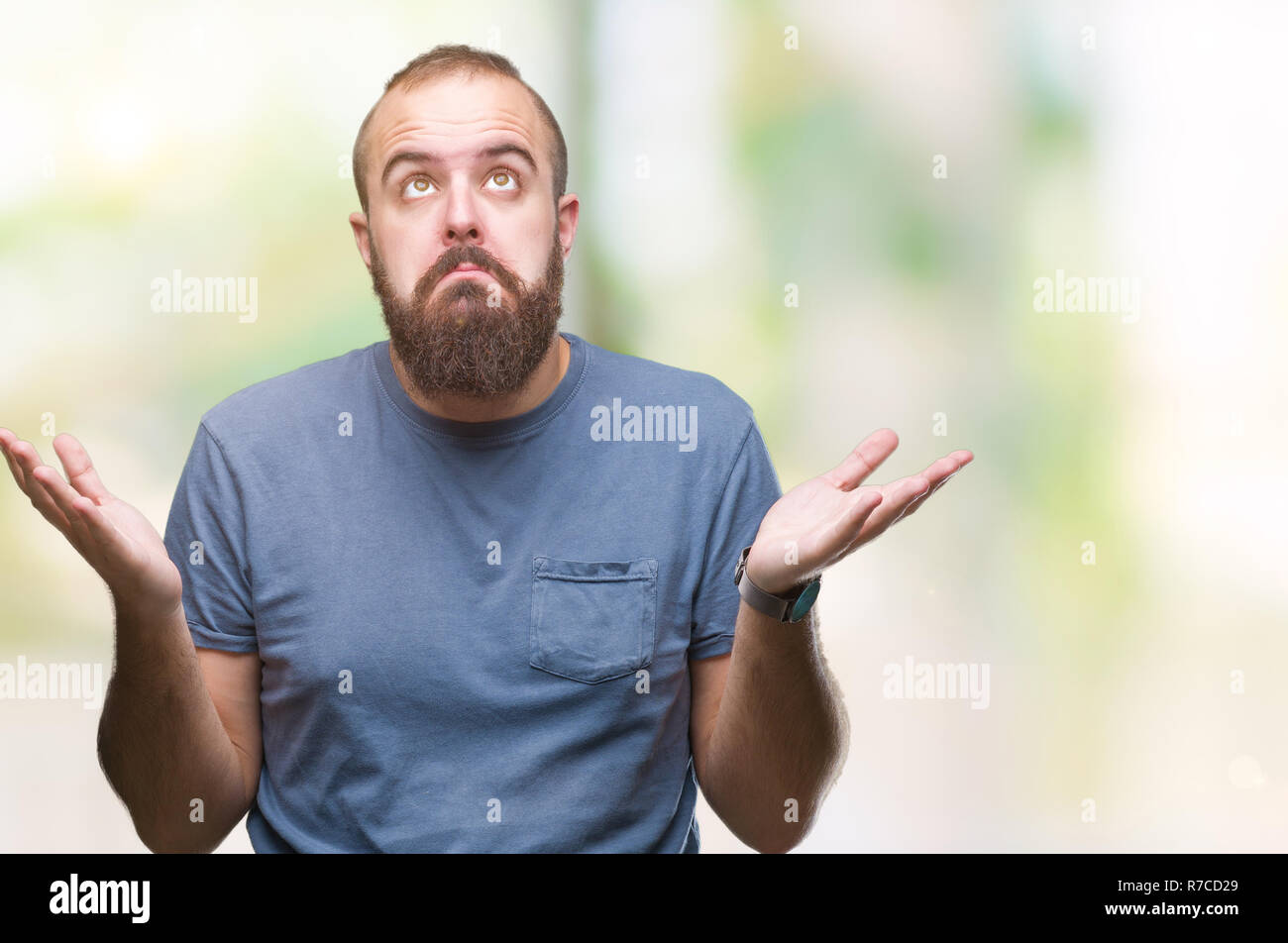 Young caucasian hipster man over isolated background clueless and ...