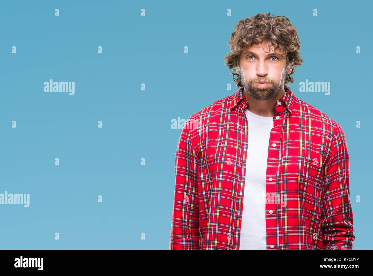 Handsome hispanic model man over isolated background puffing cheeks ...