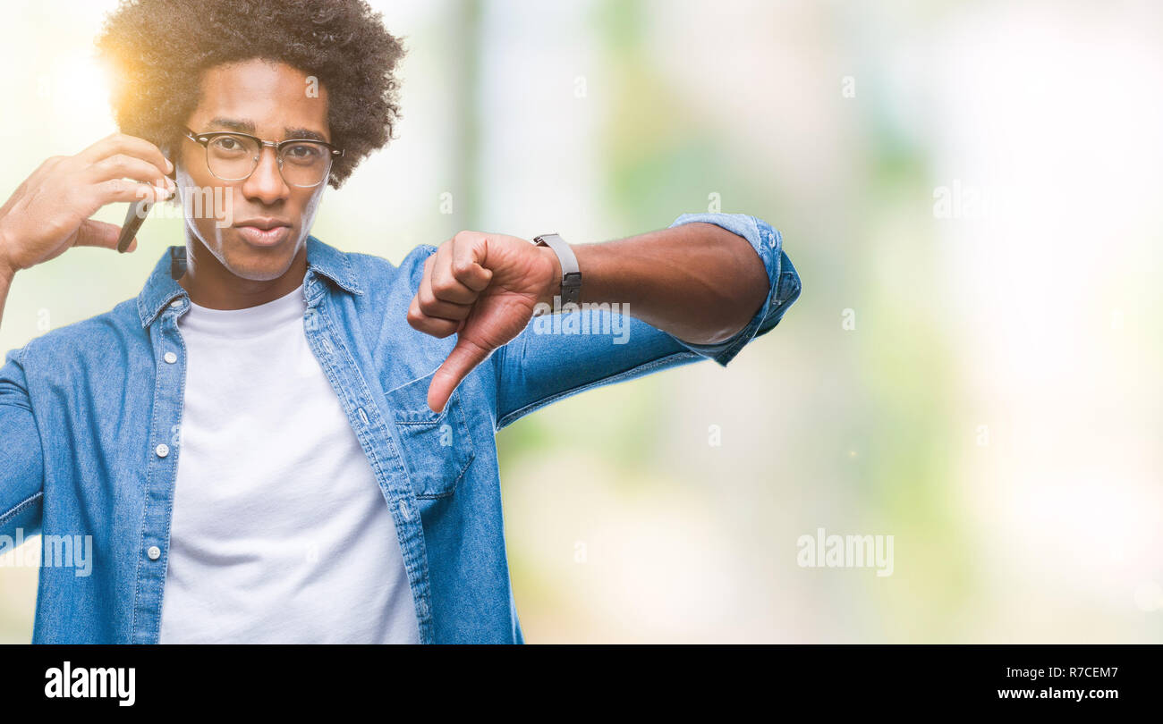 Afro american man talking on the phone over isolated background with ...
