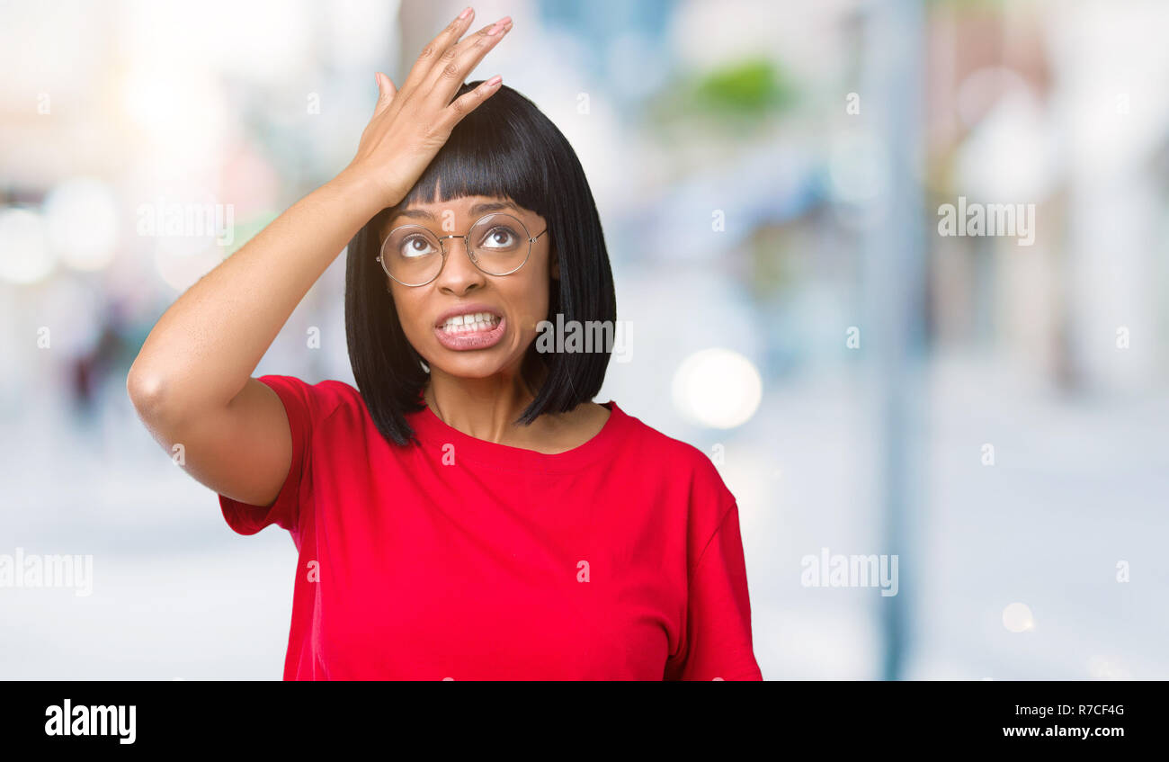 Beautiful young african american woman wearing glasses over isolated ...