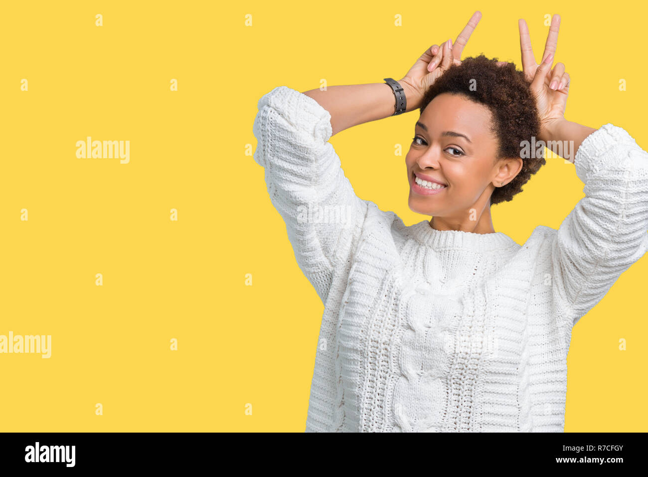 Beautiful young african american woman wearing sweater over isolated ...