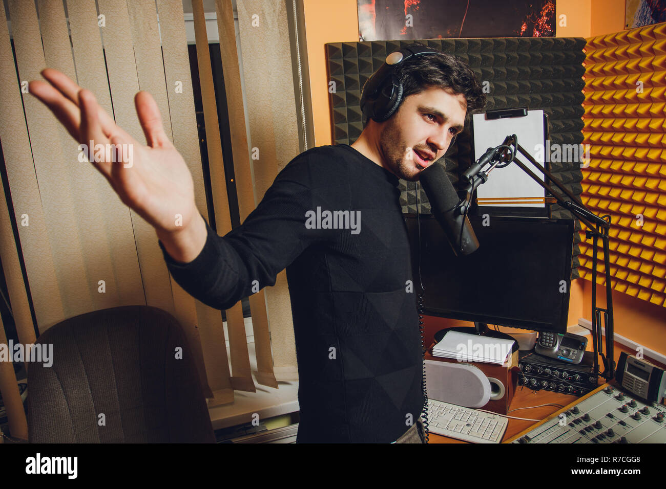 Microphone in radio studio and presenter on background Stock Photo - Alamy
