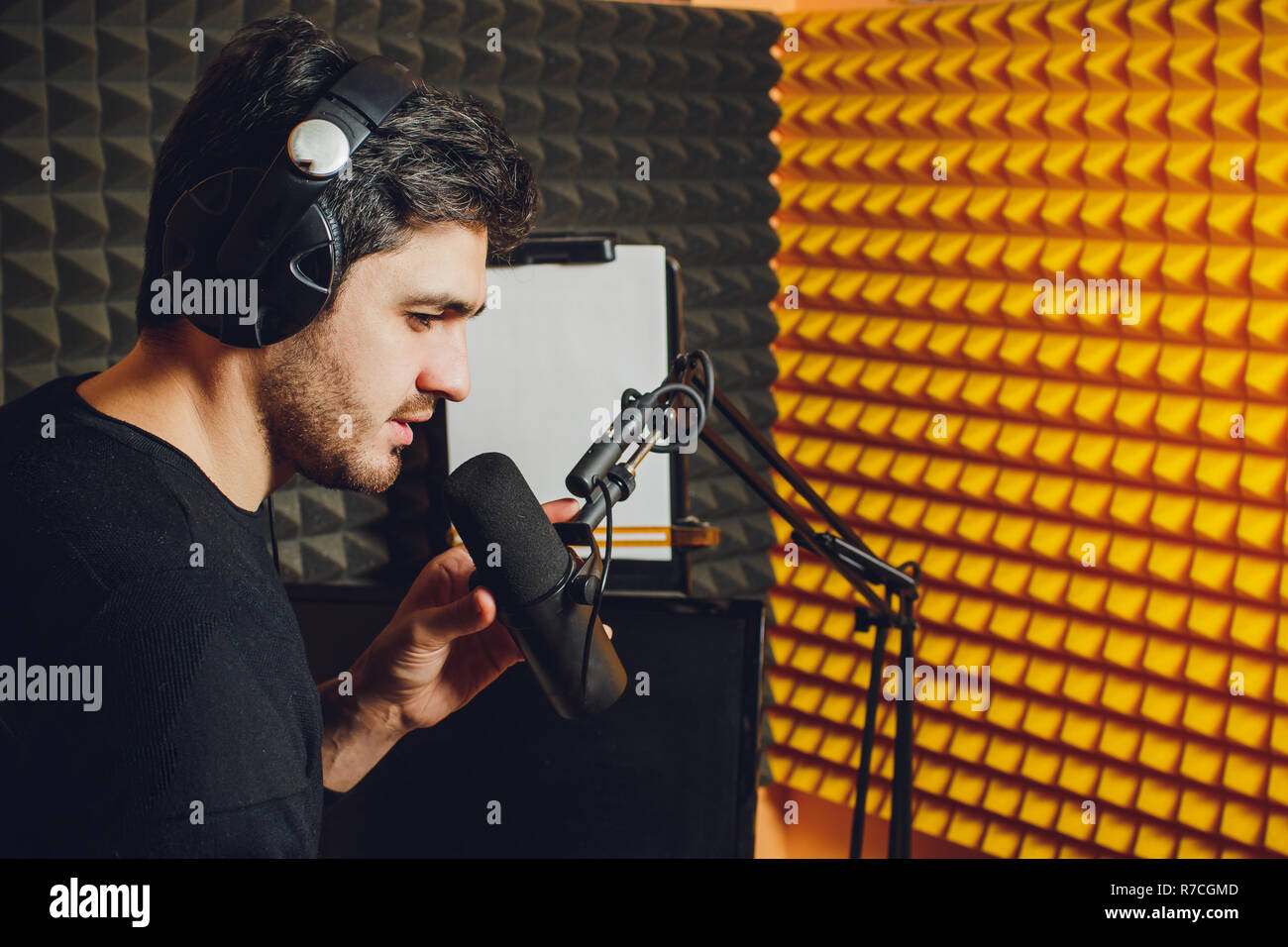 Microphone in radio studio and presenter on background Stock Photo - Alamy