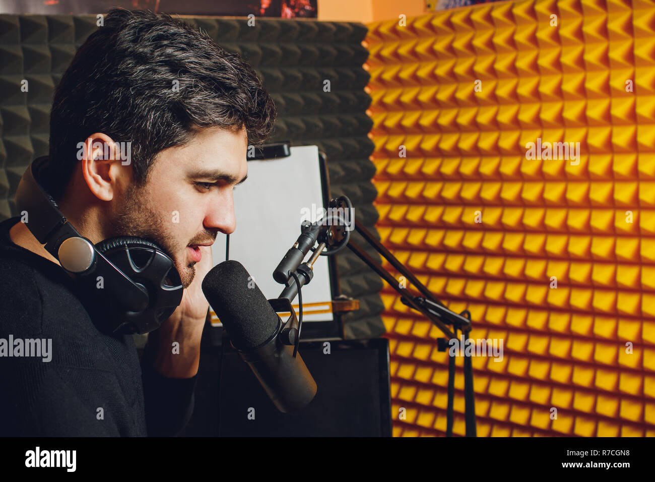 Microphone in radio studio and presenter on background Stock Photo - Alamy