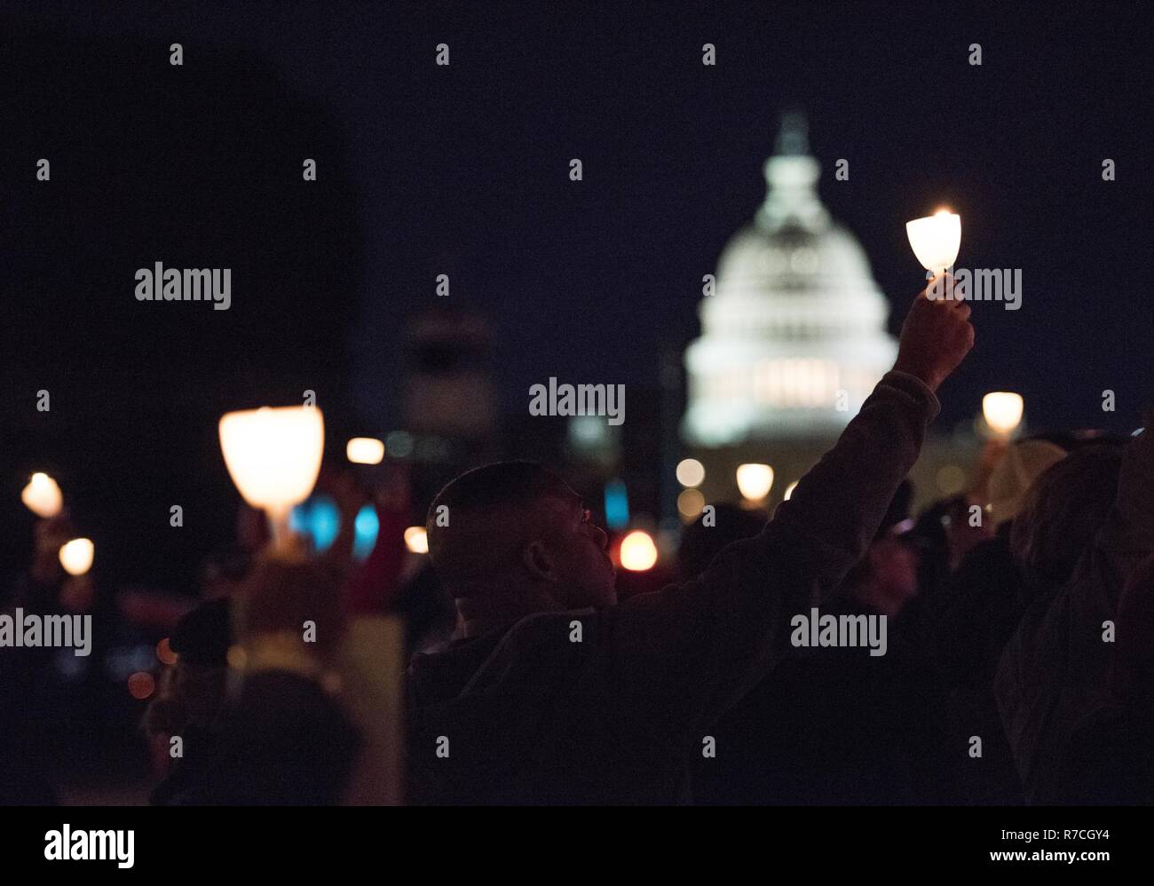 Police officers and family members raise candles during the 29th Annual ...