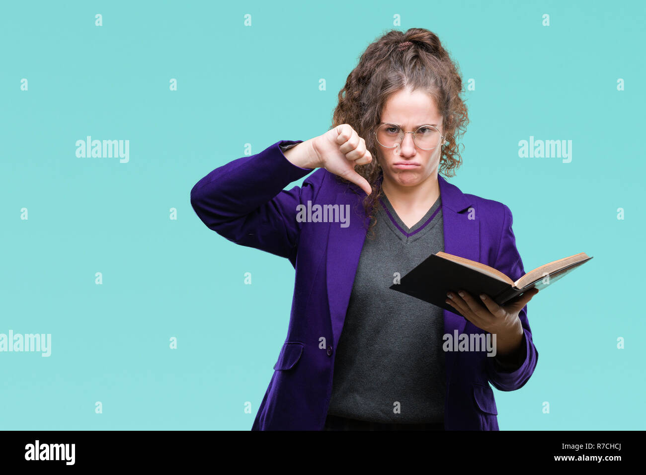 Young brunette student girl wearing school uniform reading a book over ...