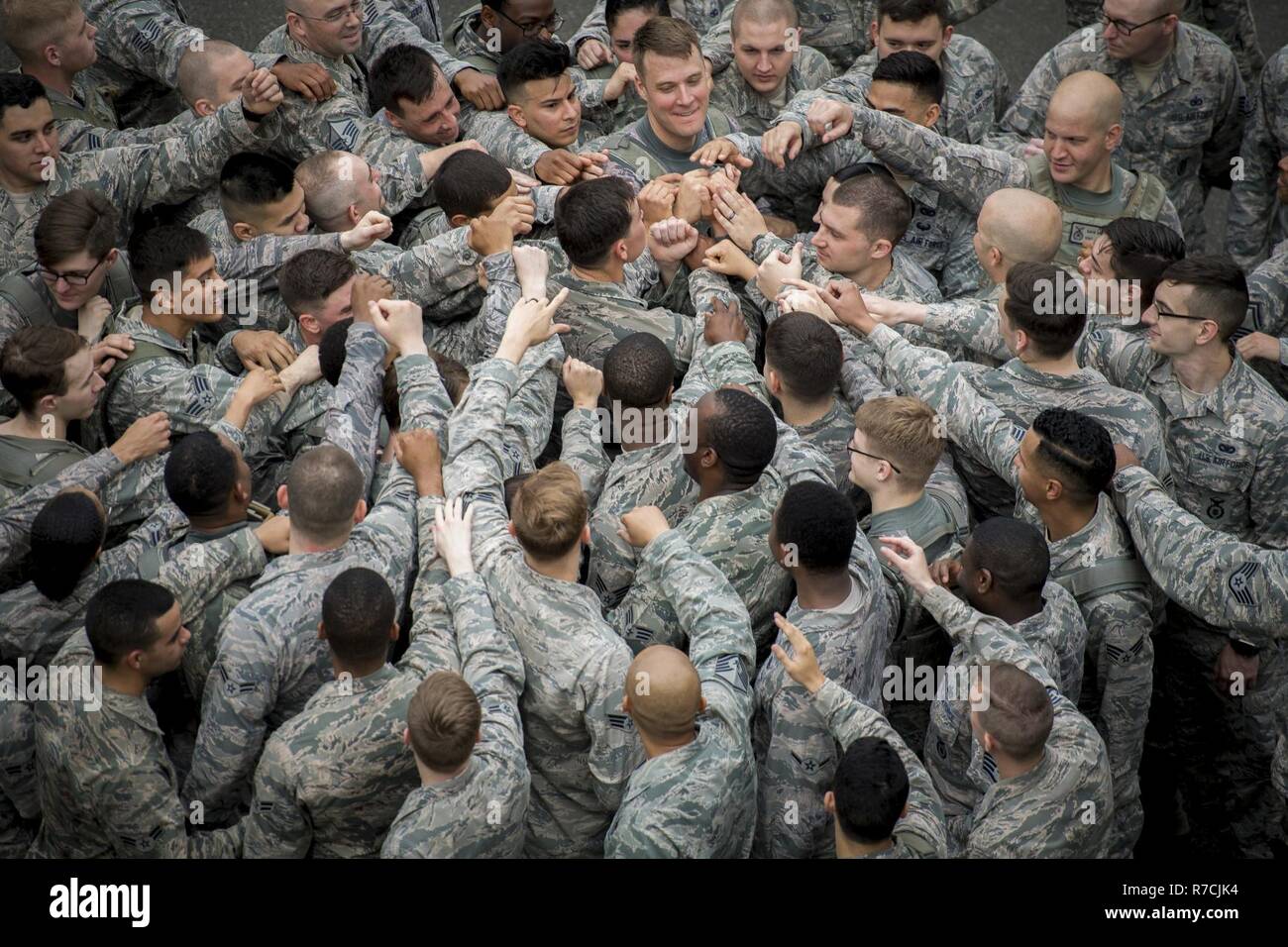 Members of the 374th Security Forces Squadron join in a group huddle ...