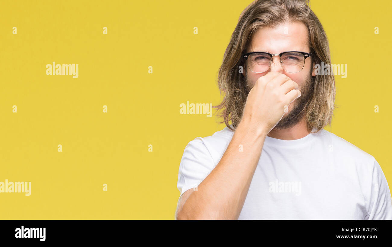 Young handsome man with long hair wearing glasses over isolated ...