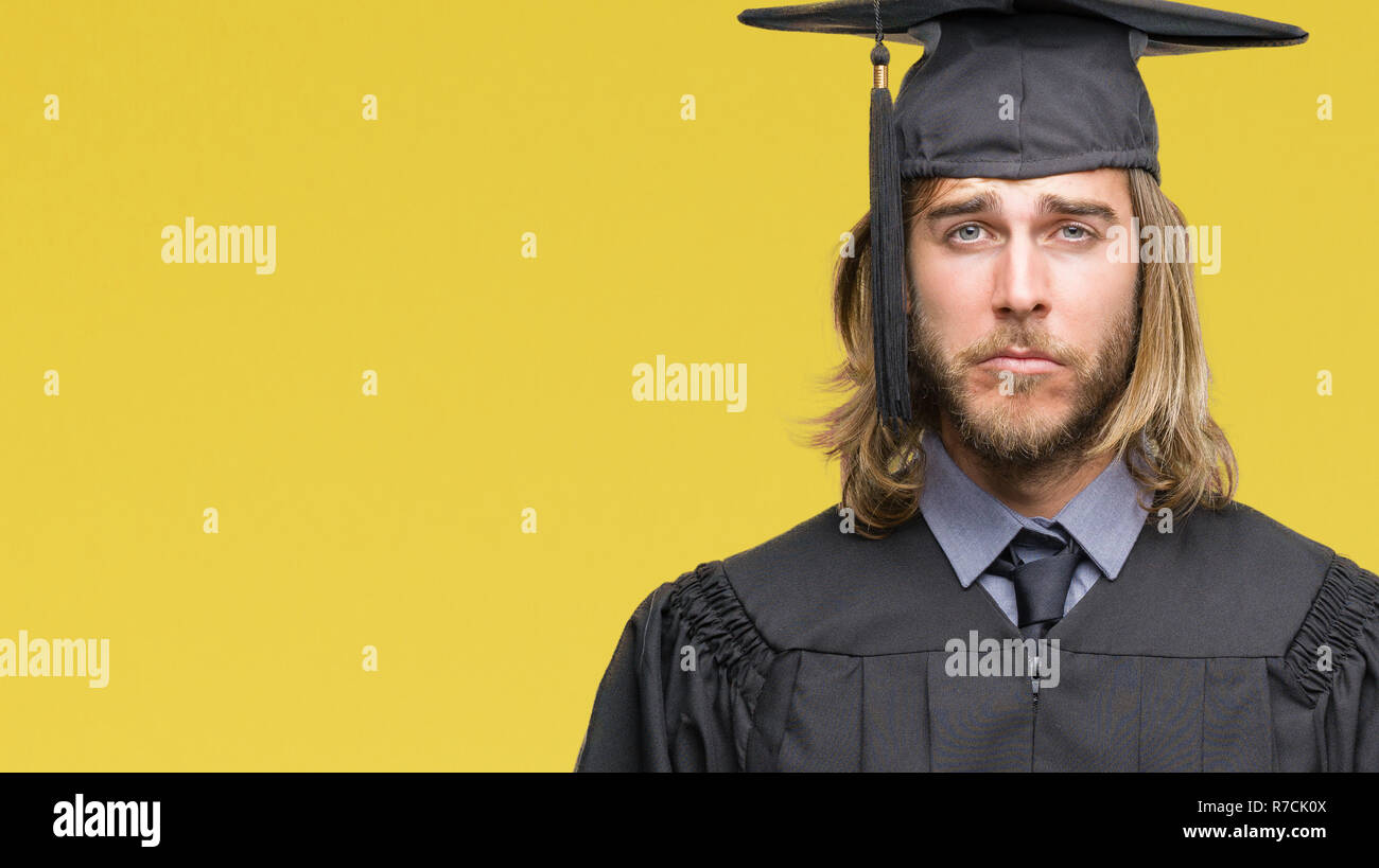 Young handsome graduated man with long hair over isolated background ...