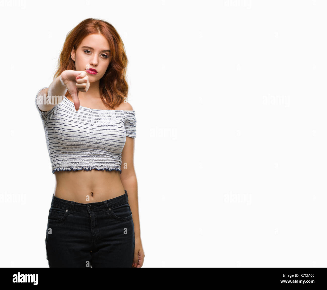Young beautiful woman over isolated background looking unhappy and ...