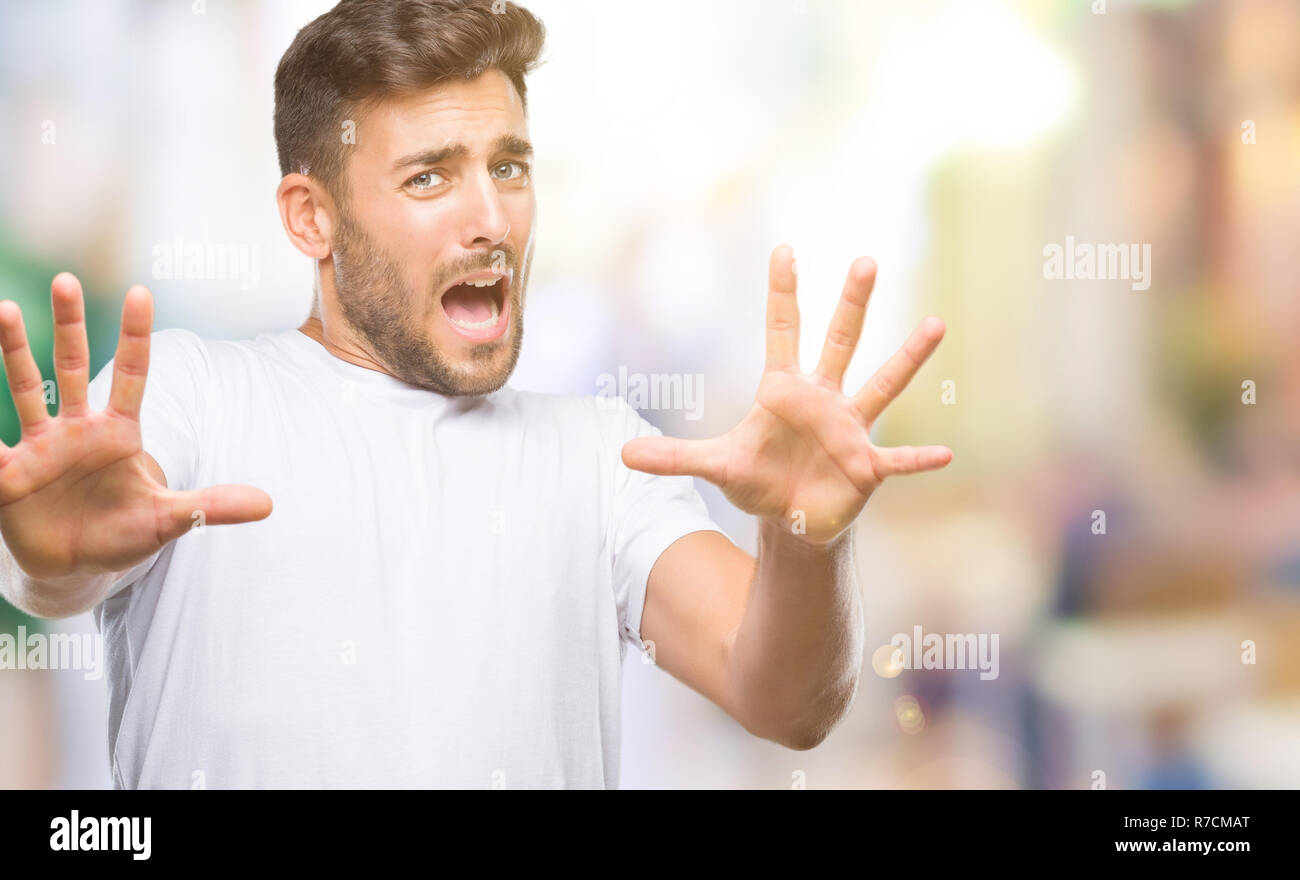 Young handsome man over isolated background afraid and terrified with ...