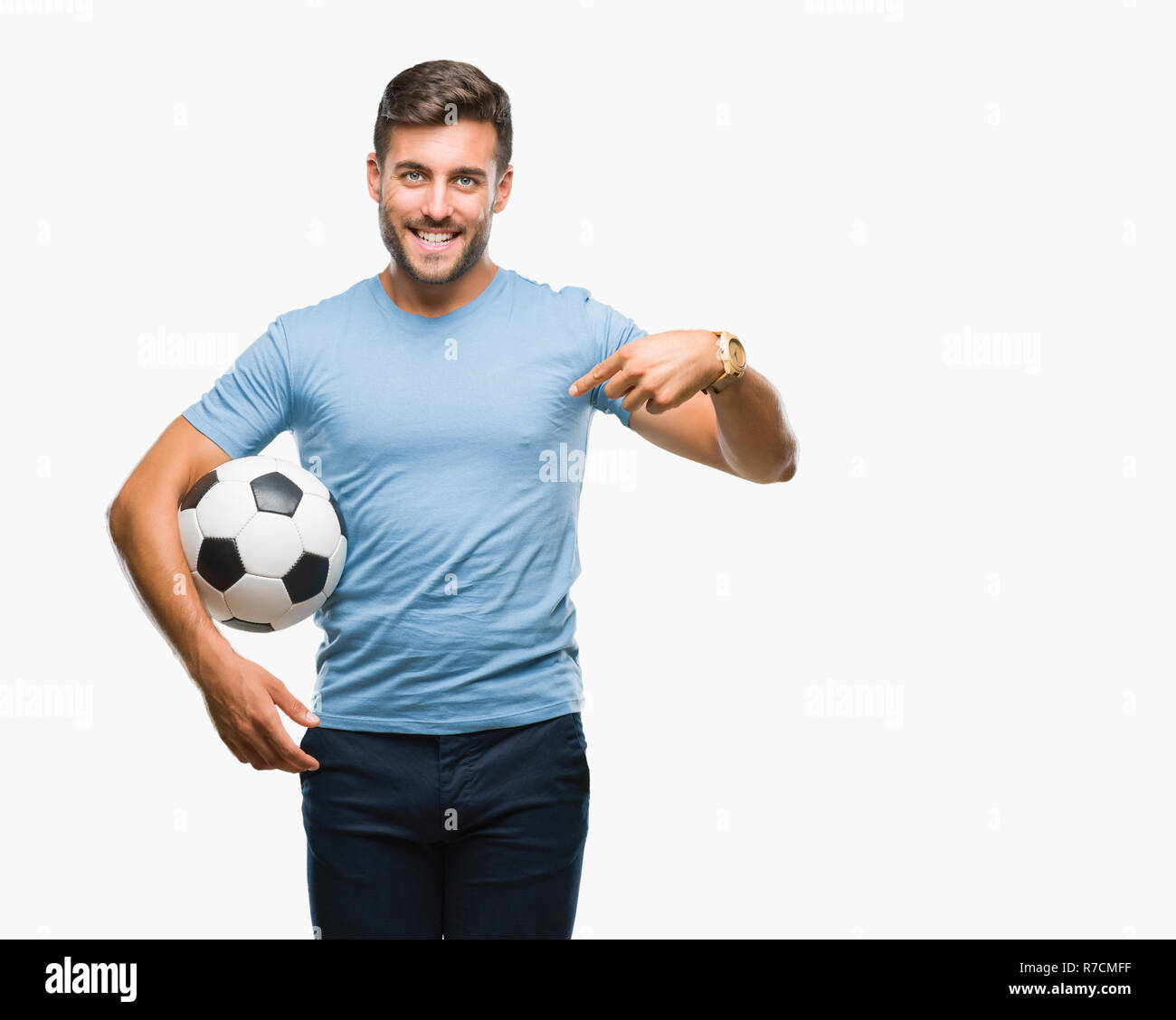 Young handsome man holding soccer football ball over isolated ...