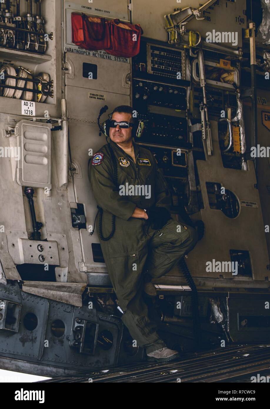 An Airman with the 729th Airlift Squadron, Air Force Reserve Command, oversees the loading of ...