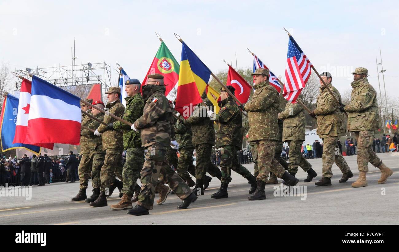 Service members from various allied and partner nations parade together ...