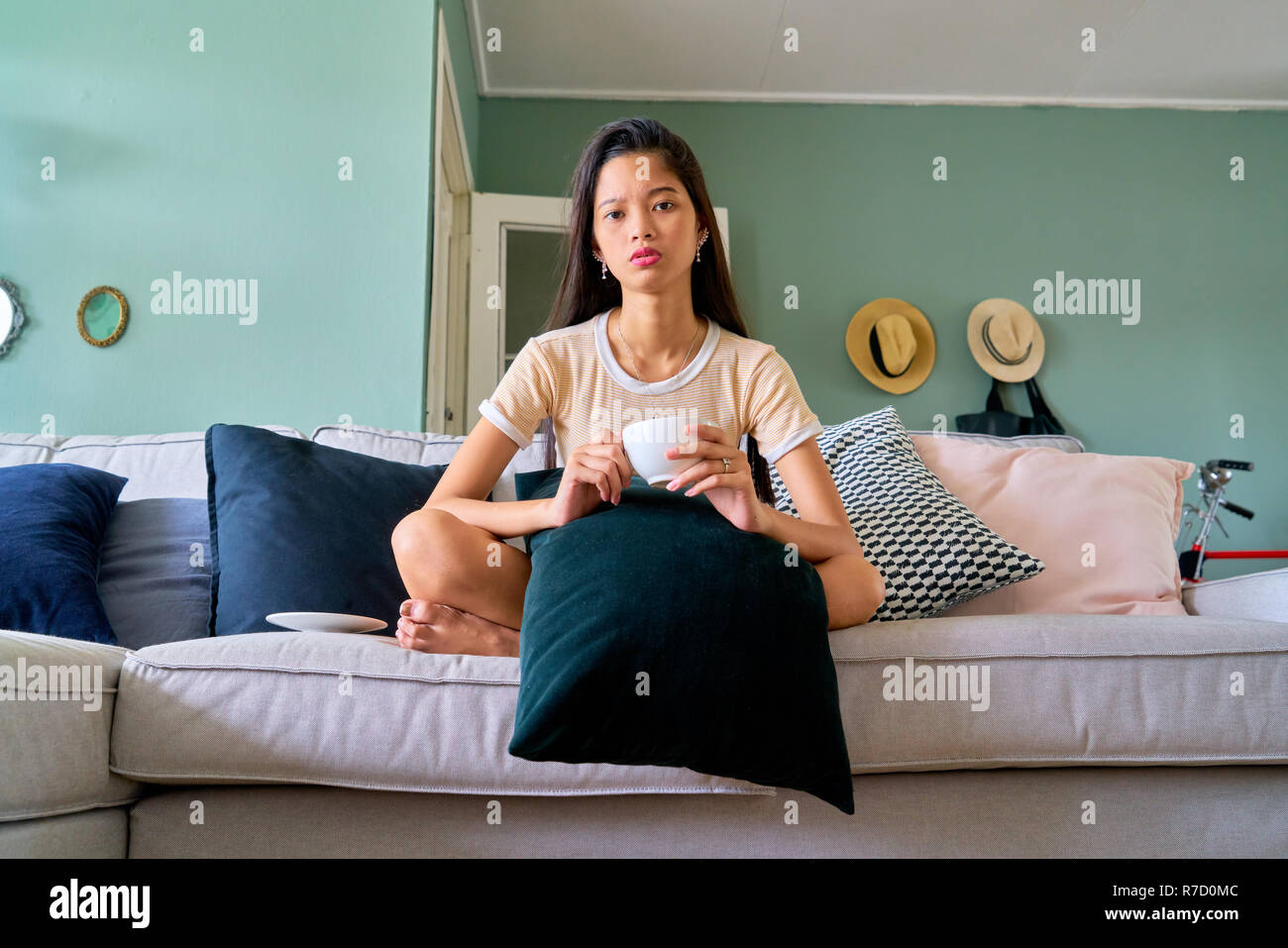 Beautiful woman posing - sitting, drinking coffee, making a face and ...