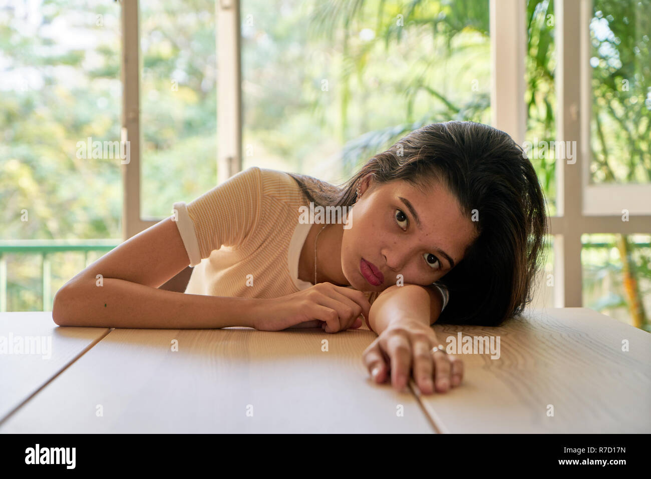 Beautiful woman posing - sitting and tired Stock Photo - Alamy